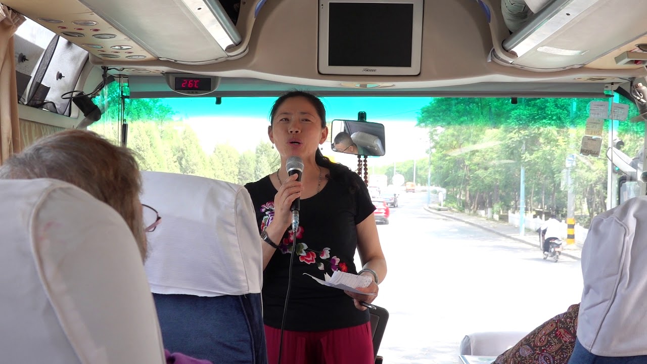 Chinese tour guide Eva singing and talking on the bus in Beijing - YouTube