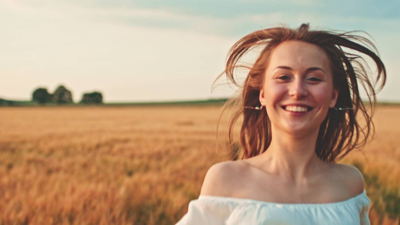 beautiful girl running on sunlit wheat field slow motion 120 fps ...