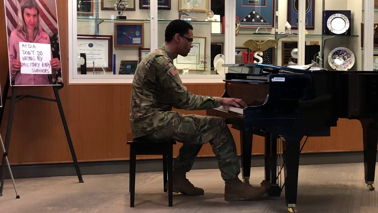 Video of young soldier playing piano - YouTube
