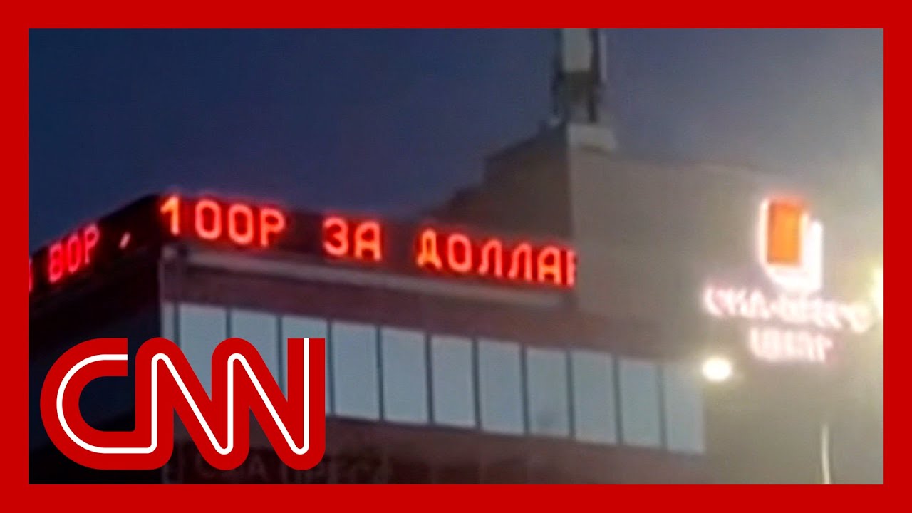 News ticker on Russian building blasts Putin as Ruble sinks - YouTube