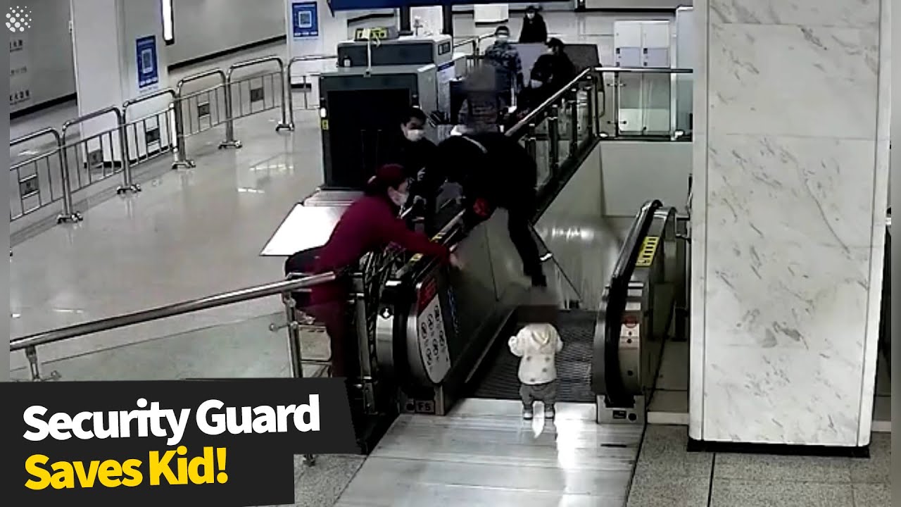 Security guard hops over handrail to stop toddler from falling down ...