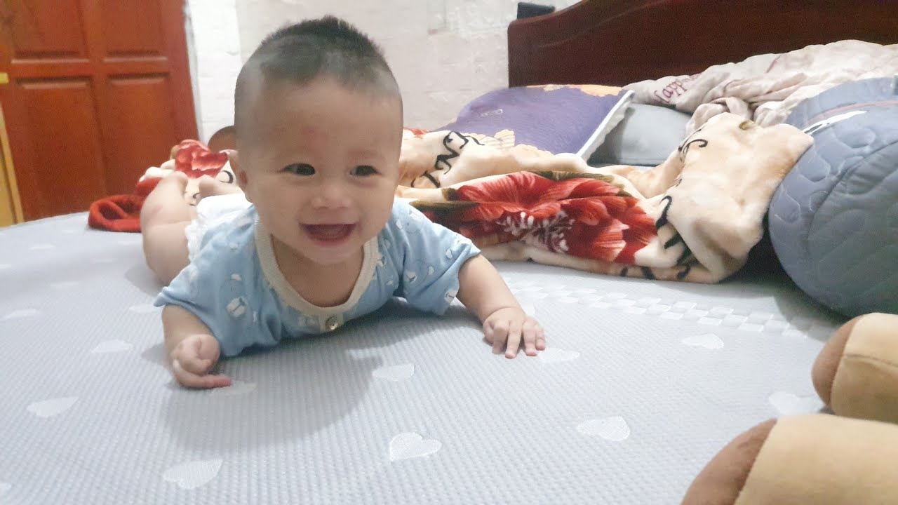 cute baby is learning to crawl and likes to eat fingers and toes - YouTube