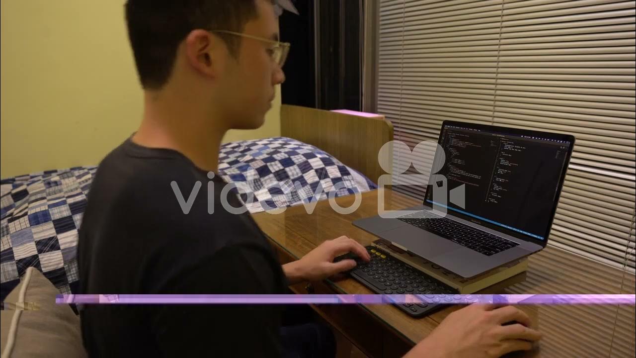 Programmer Sits In Front Of Laptop With Visual Studio Code On Screen ...