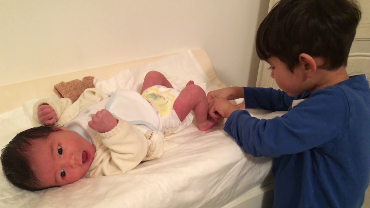 Kid Helps Parent To Change Diaper And Dress Up For His Newborn Brother ...