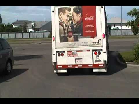 A Coca Cola Shipment Truck Starting Up and Driving Off From the ...
