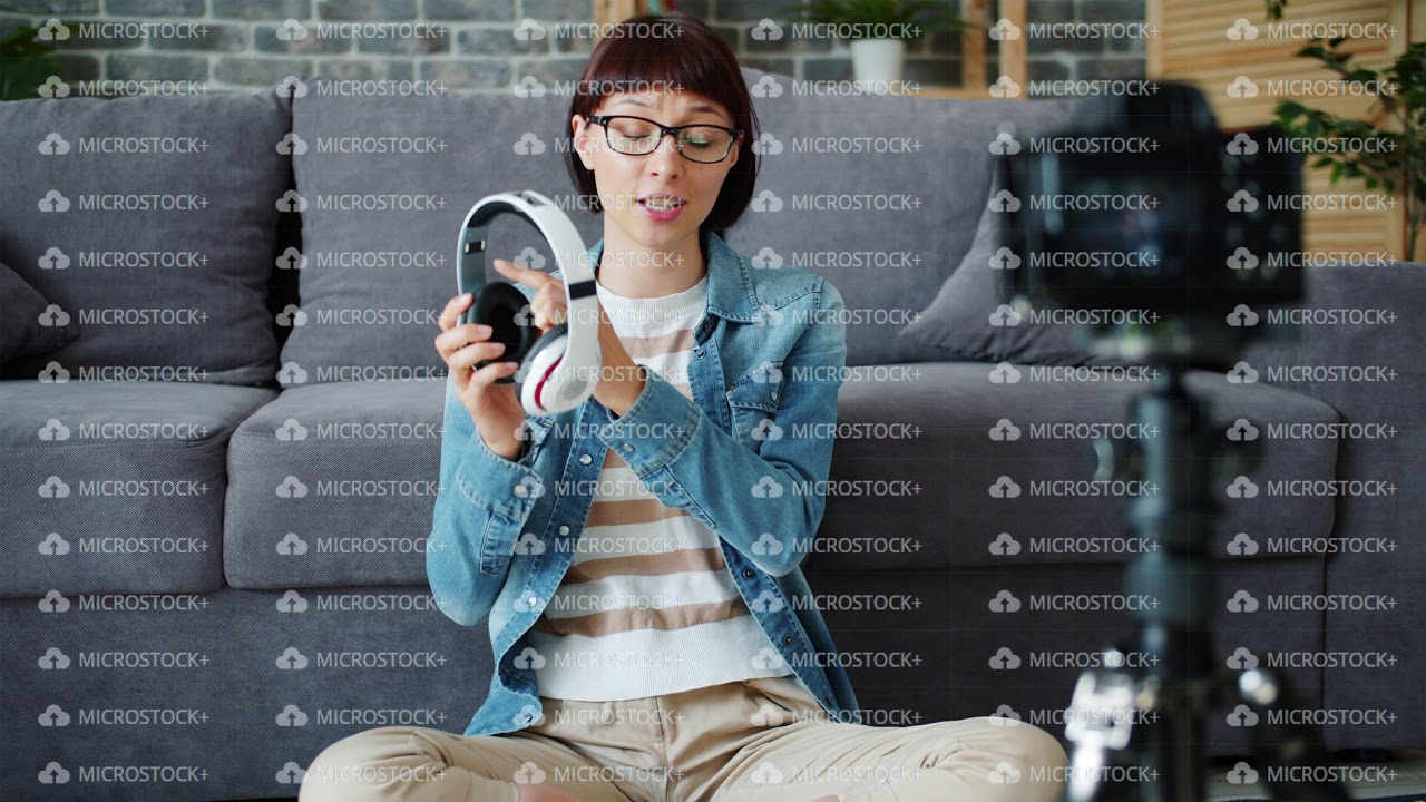 Gadget expert recording video about new headphones talking for camera ...