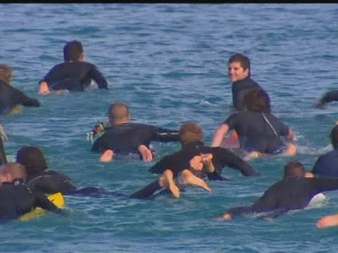 A ring of surfers: A tribute to a shark attack victim - YouTube