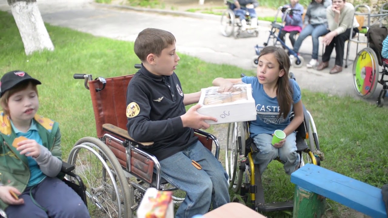 children with physical development disorders on wheelchairs eating ...