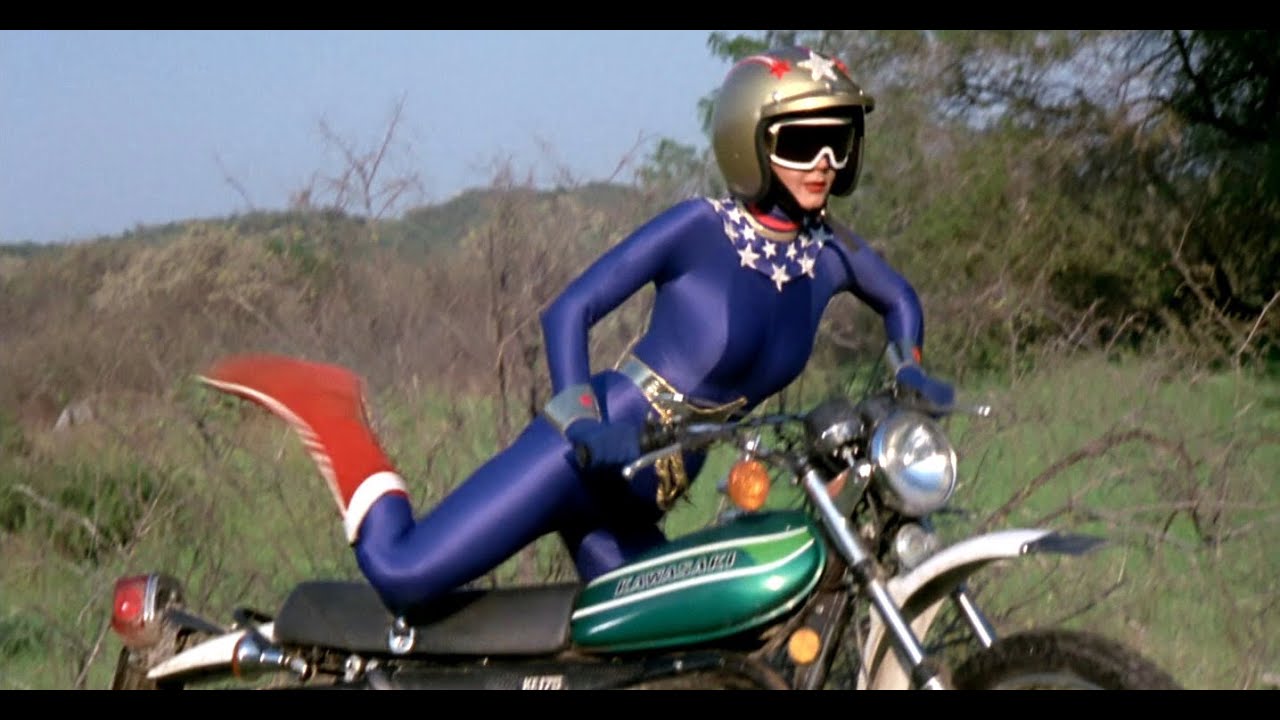 Wonder Woman Looking Sexy in Her Spandex Catsuit Riding A Motorcycle ...