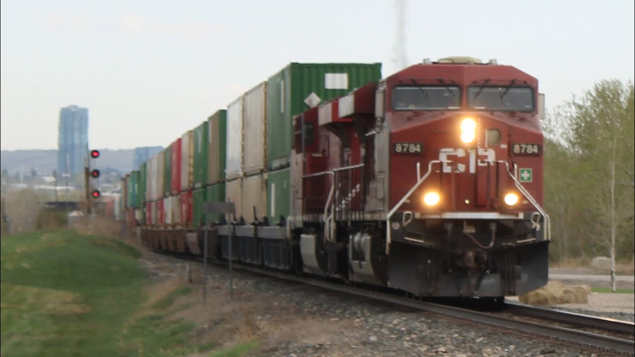 CP rumbling mix freight train with shiny CP ES44AC in middle leaving ...