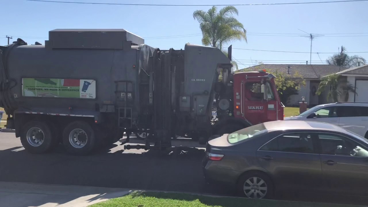 Ware disposal Peterbilt 320 Amrep elliptical truck #79 driving down ...