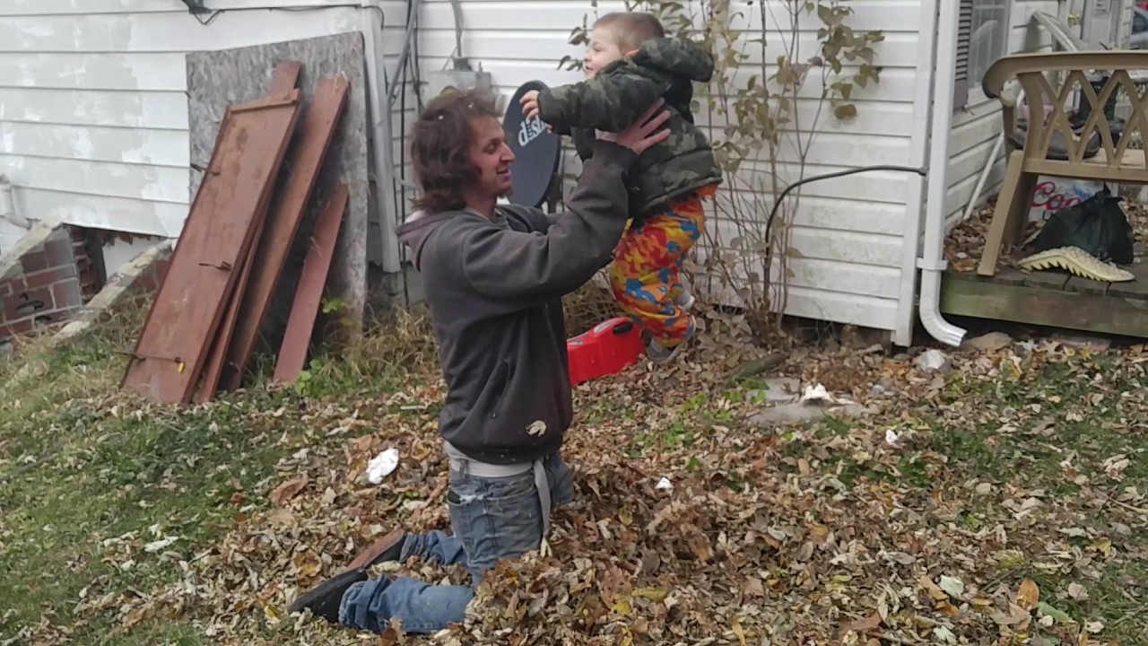 Zach attack: Andy and Zachary have a blast with a pile of Autumn leaves ...