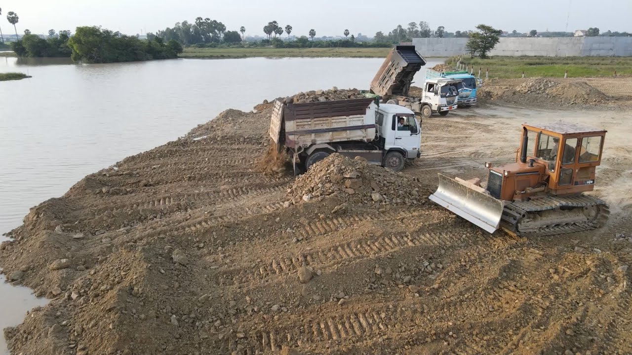 Good Job ! Mighty Mini Komatsu Dozer Operated pushing rock with dump ...
