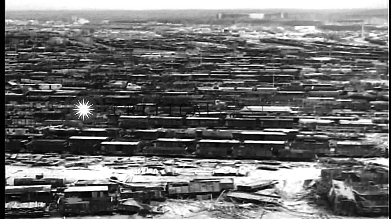 Damaged boxcars, locomotives, freight cars and a wrecked railroad in ...