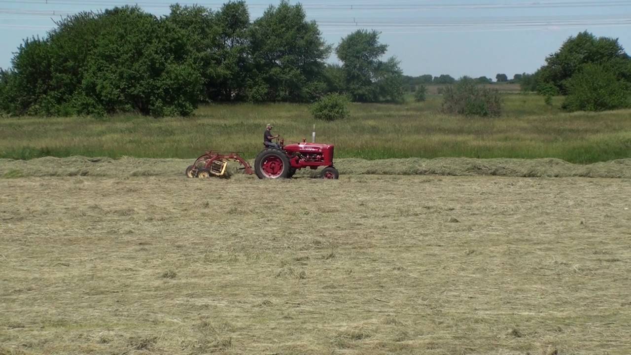 Farmall Super M Raking Grass Hay - YouTube