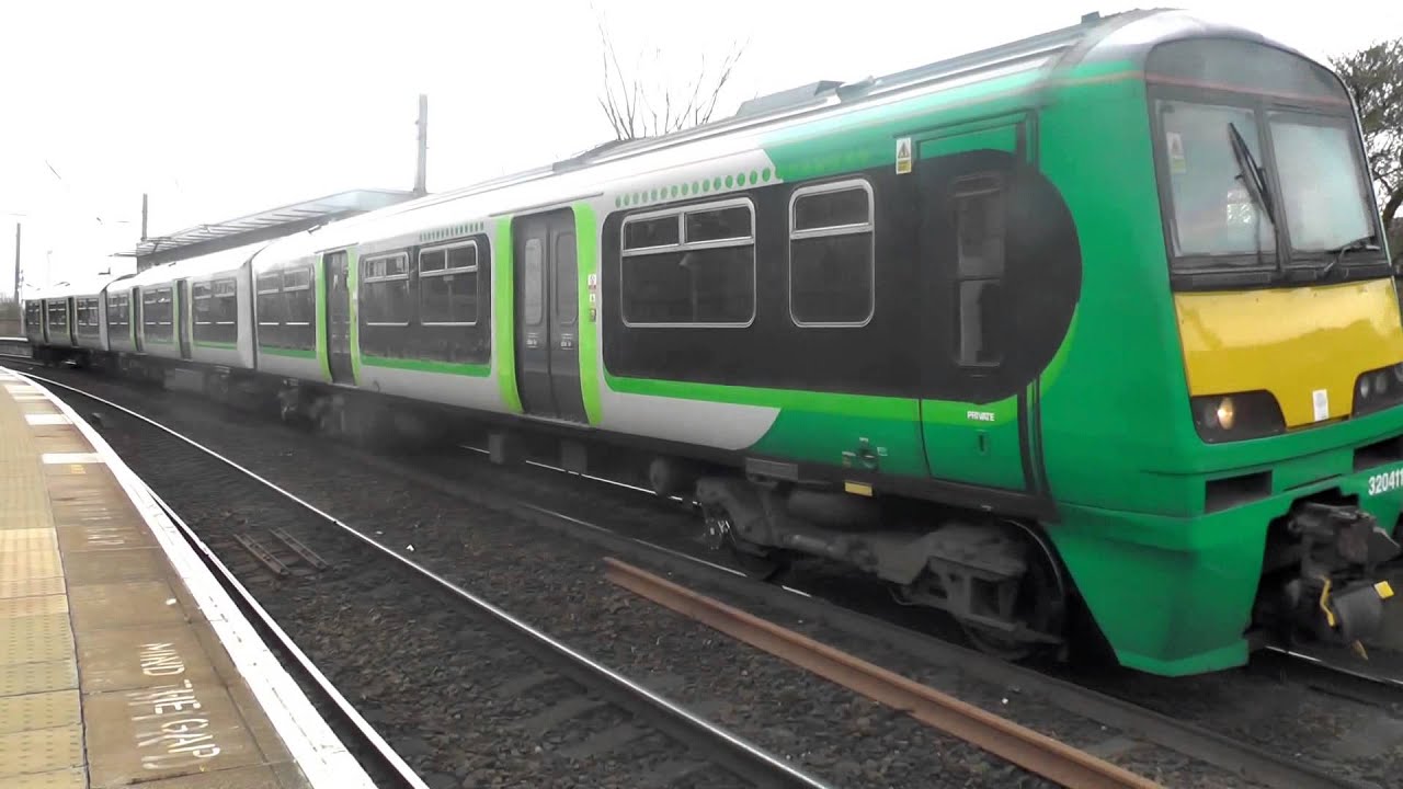 320 411 pulls into Partick station on a Dalmuir service whilst 318 259 ...