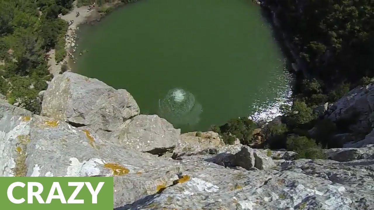 Insane daredevil jumps from 34 meter cliff into water - YouTube