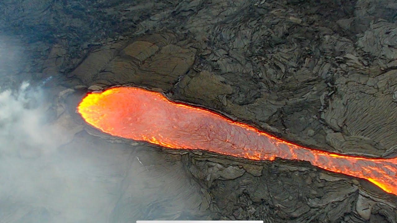 Lava breaks out from under the crater in a spring that expands into a ...
