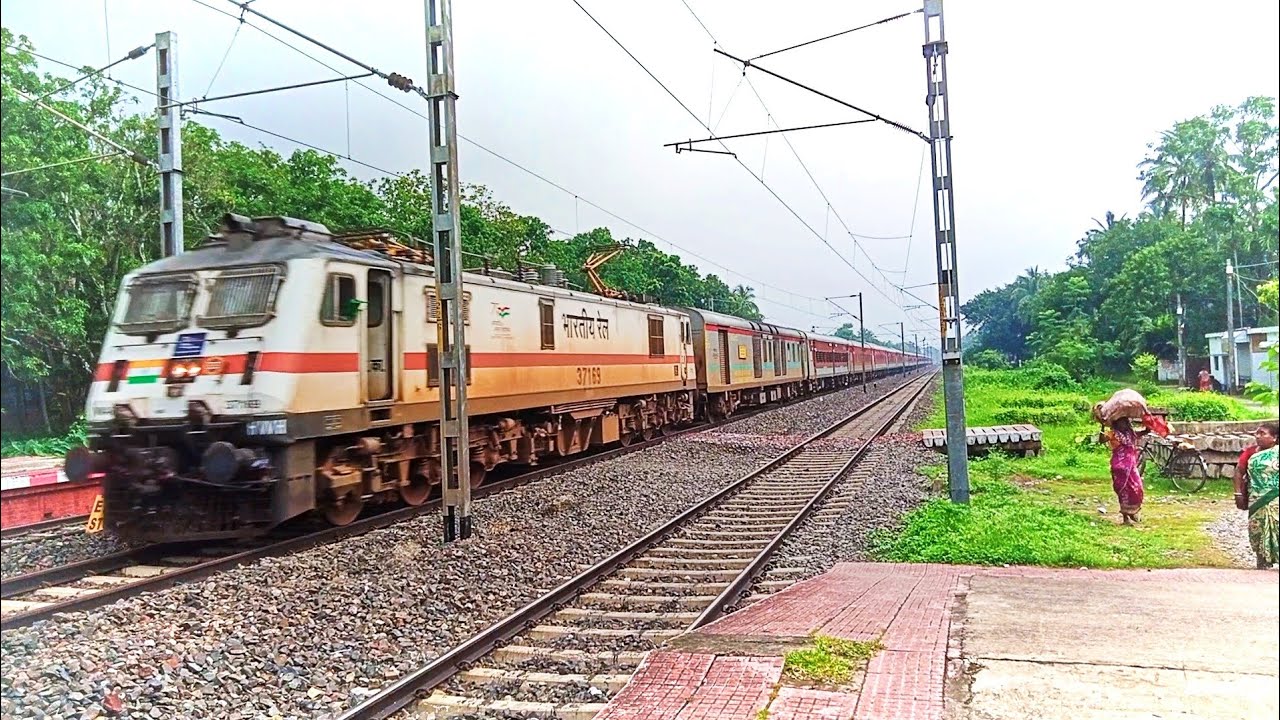 Beautiful red LHB coach WAP7 locomotive kamrup express train in moving ...