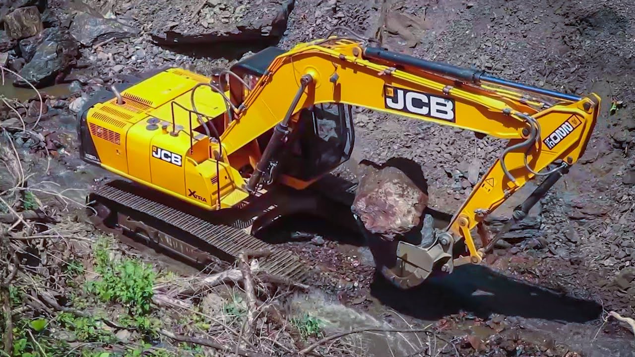 JCB Backhoe Cleaning River, Removing Stones and Working For Road ...