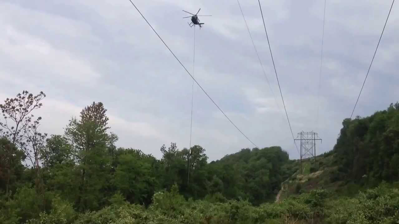 Helicopter cutting trees along the power lines down the mou - YouTube