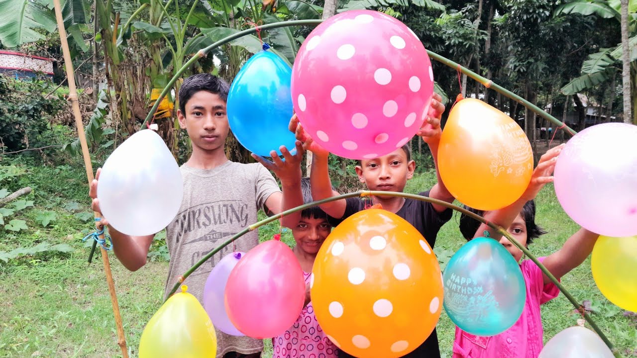 The children make a bamboo ring frpn balloons and burst the balloons ...