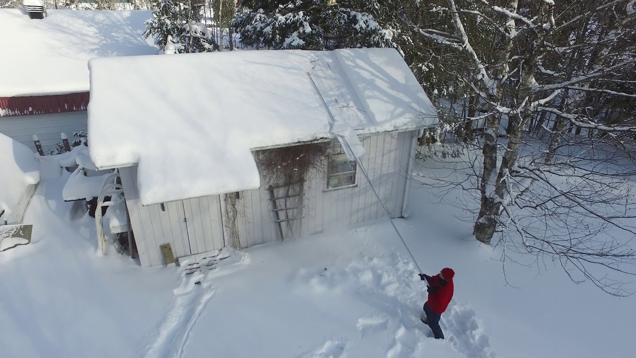 Clearing snow off detached Garage roof with snow shovel SnowPeeler ...