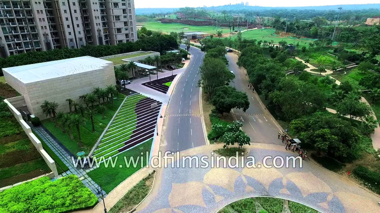 Aerial: Luxury pool and lush greenery of DLF Golf and Country Club ...