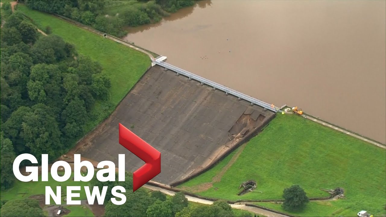 English town evacuated after water cascades through damaged dam - YouTube