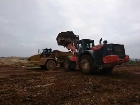 Hitachi ZW 550-5 loading topsoil on a Caterpillar 740 Dumper - YouTube