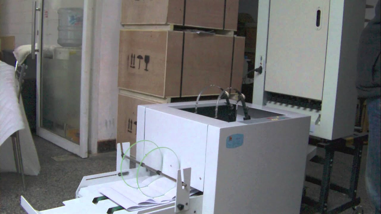 Paper Collator and wire stitcher - YouTube
