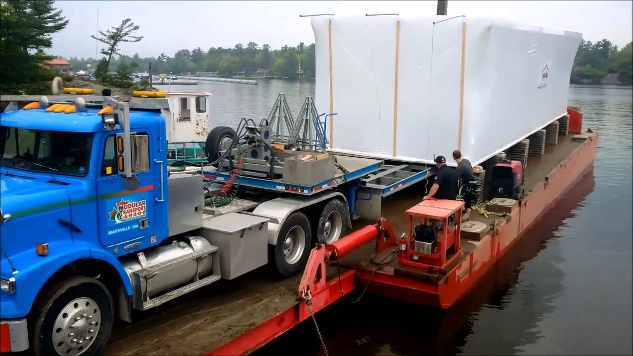 Modular Transport Canada loads a house onto a barge - YouTube