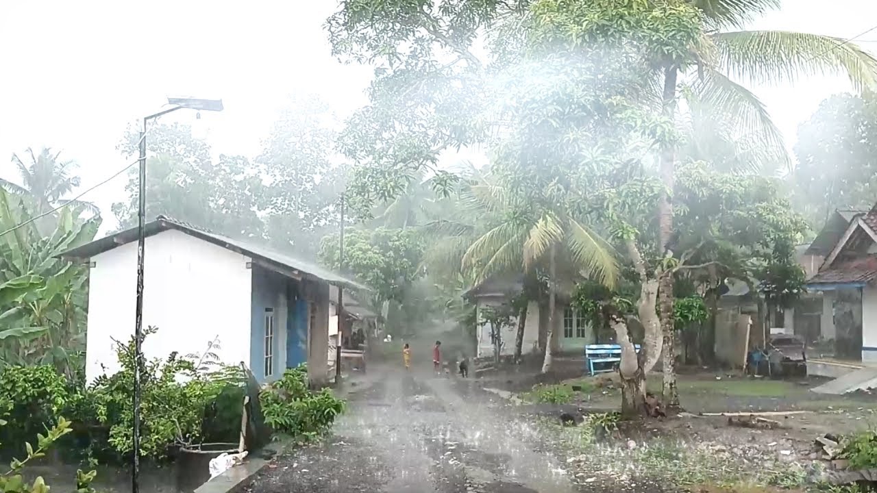 Village children are happy under heavy rain and thunderstorms enjoying ...