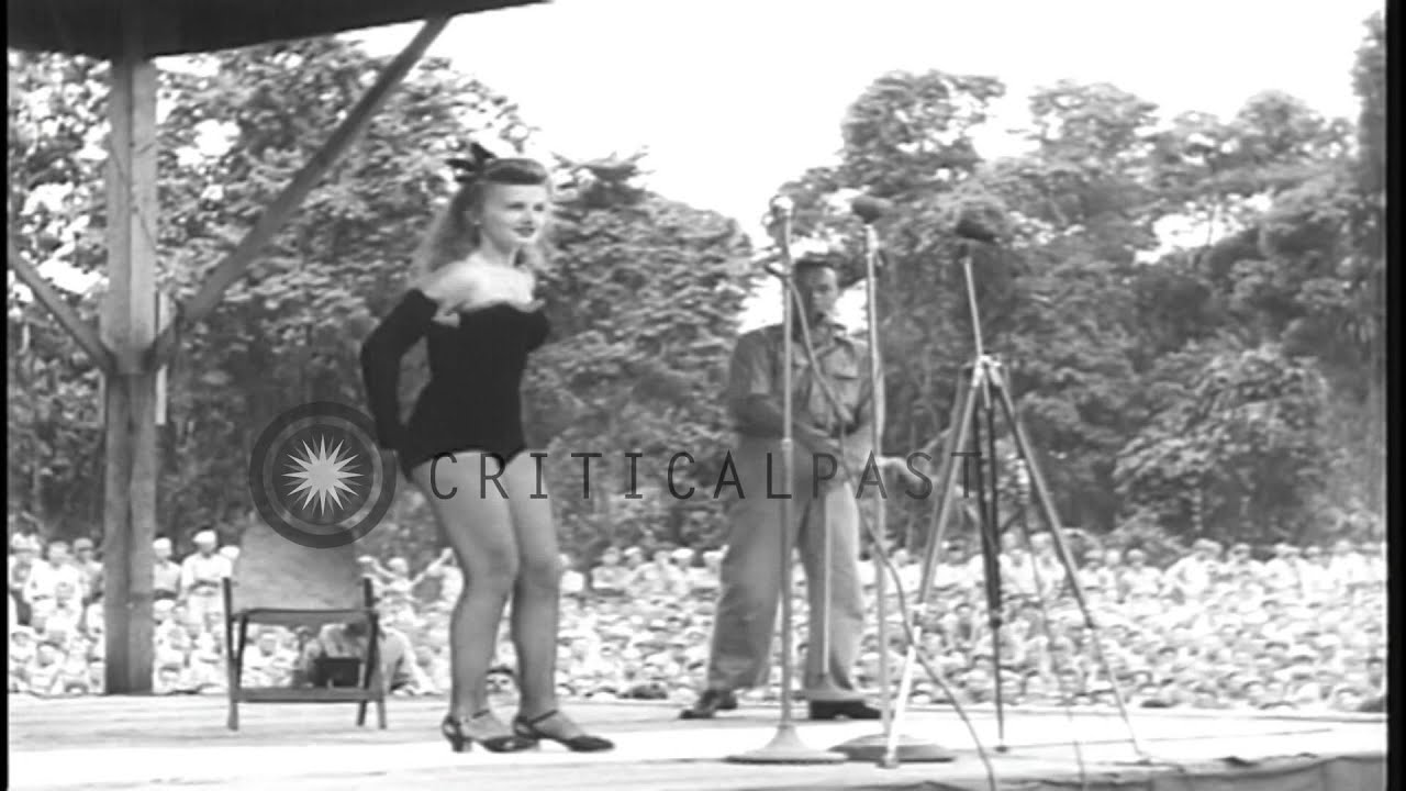 Bob Hope introduces Patty Thomas who performs a dance for US soldiers ...