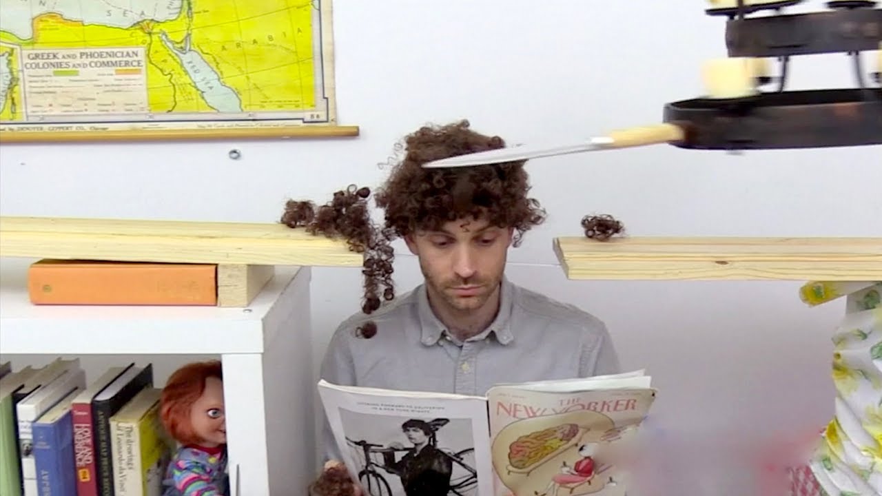 Kinetic artist introduces hair-raising automatic hair cutter - YouTube
