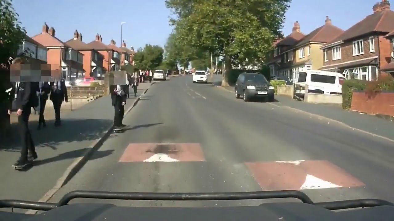kid using phone hits curb and falls off skate board wrong side of road ...