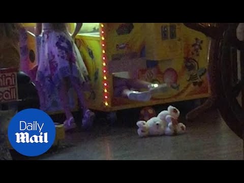 Little girl gets stuck inside claw machine when looking for a teddy ...