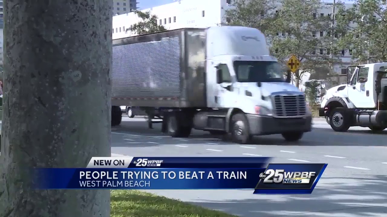 Video shows people trying to beat a train - YouTube