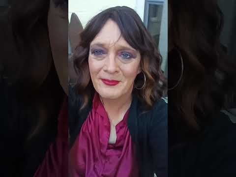 Goth crossdresser in a leather mini skirt on her smoke break