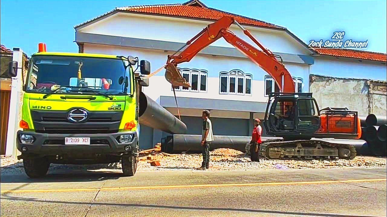 Excavator Working to Lift Iron Pipe Piles to Tronton Truck - YouTube