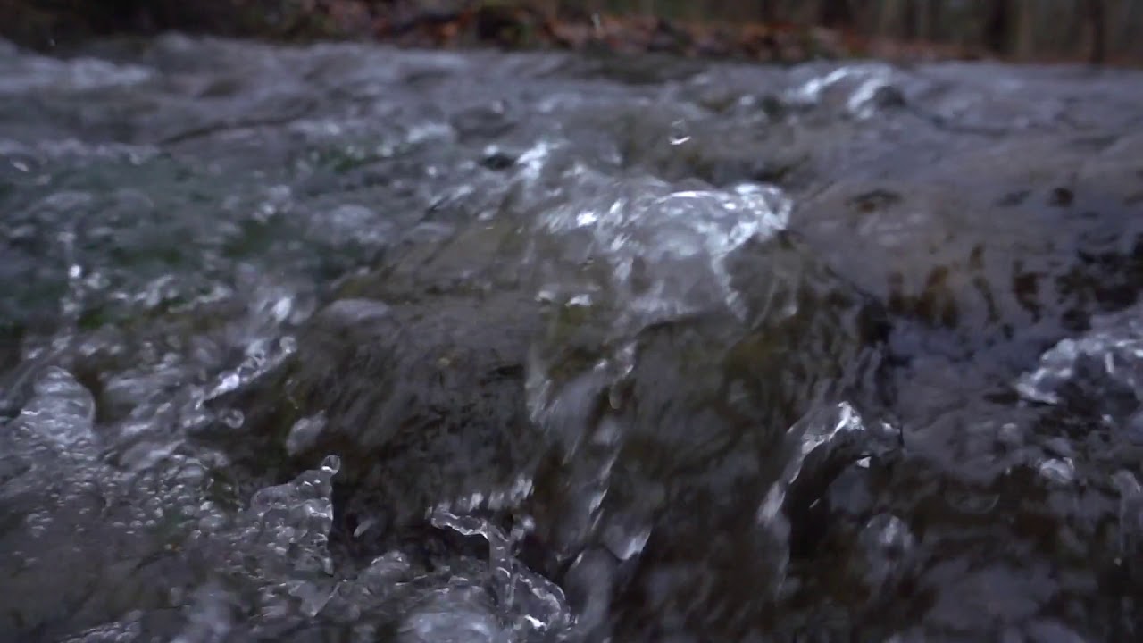 slow mo waterfall rapids splashing over rocks snowing - YouTube