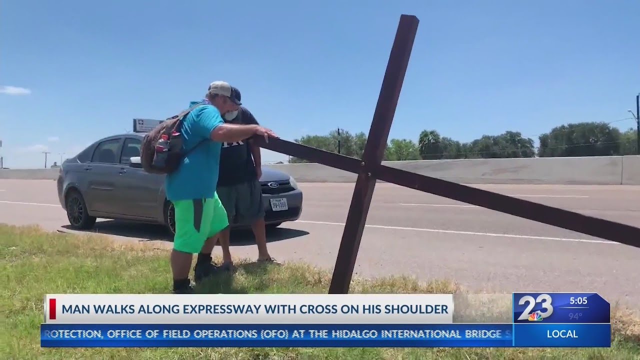 Man walks with cross on along expressway - YouTube
