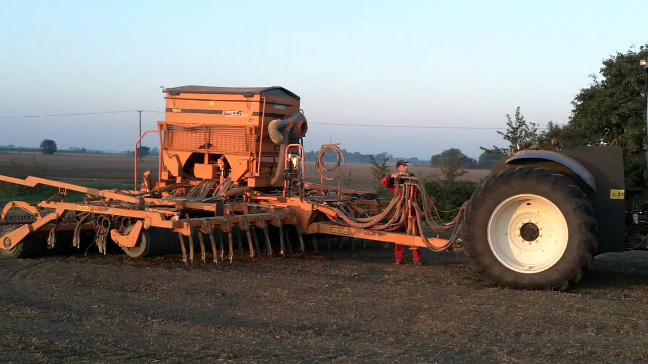 Simba 8 metre Free Flow Drill pulled by New Holland T9050 - YouTube