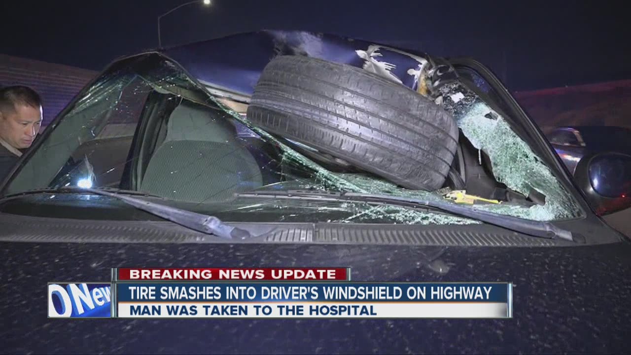 Loose tire flies through truck windshield on freeway, driver hurt - YouTube