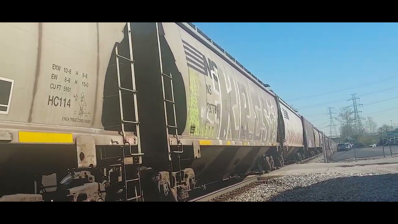 Westbound NS loaded covered hopper train at City Centre Dr, passing an NS intermodal sitting for ...
