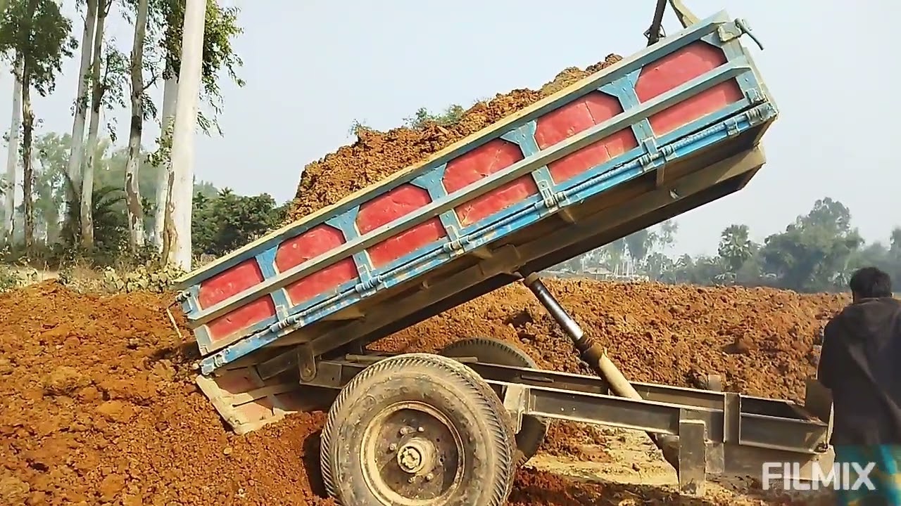 The tractor video shows the soil being carried by tractors from a long ...