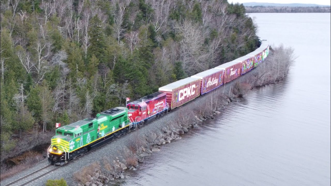 Awesome 4K View! CPKC Holiday Train passing Lake near Harvey, NB on ...