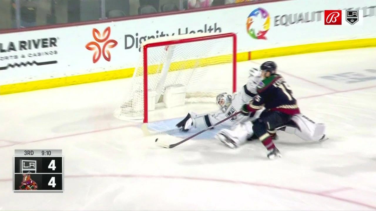 Cam Talbot reaches back with his arm while on his back to make the save ...