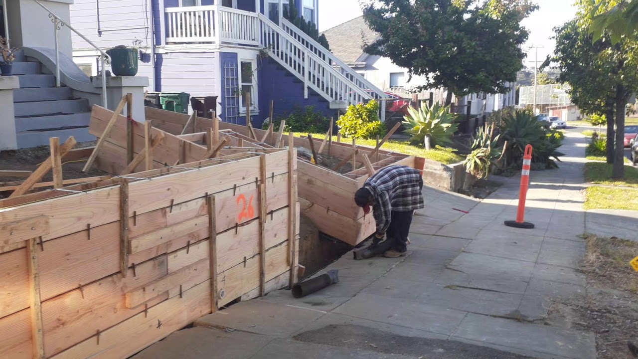 Veterans concrete,...pre pour wall thru @ new retaining walls - YouTube