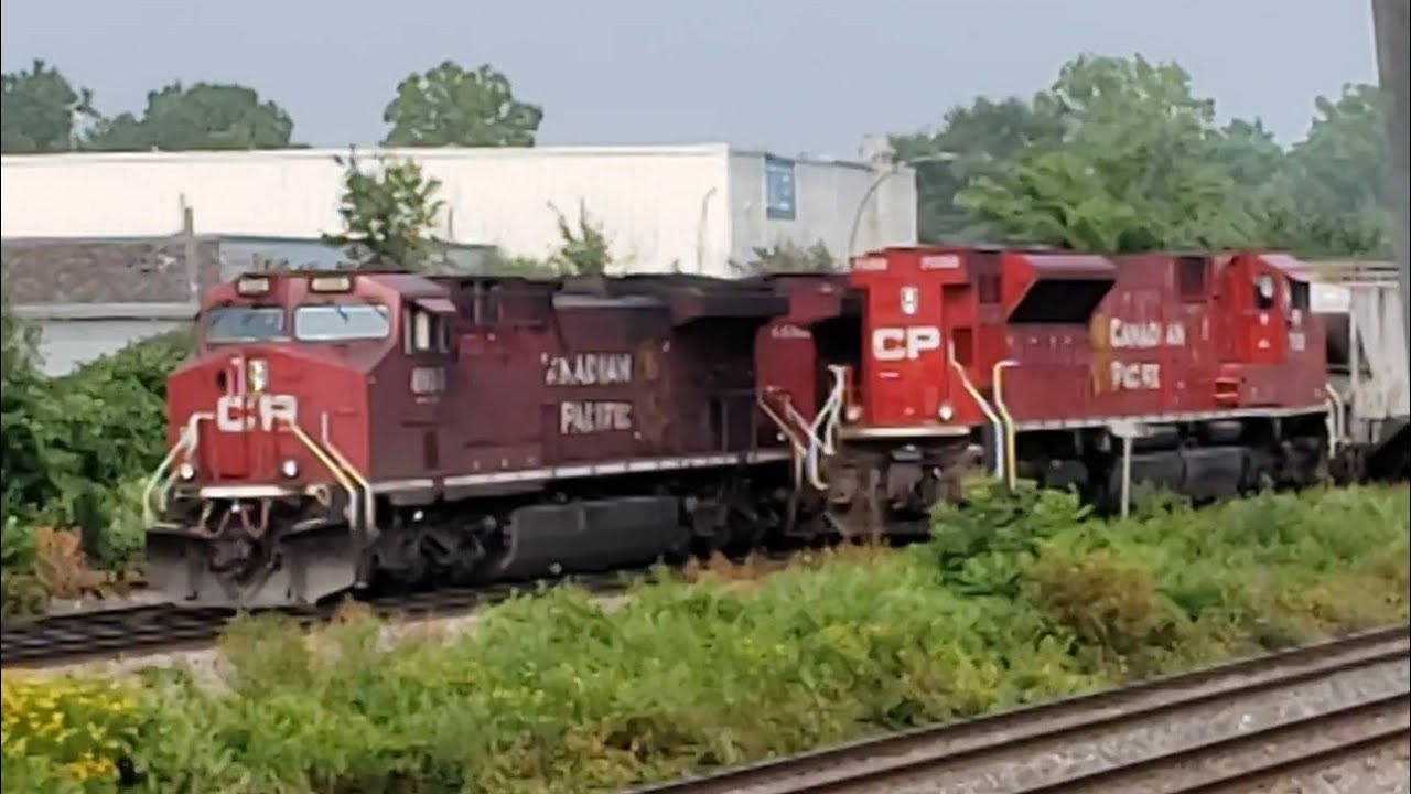 TRAINS CP Unit Tanker Meets Parked Intermodal at Dorval - YouTube
